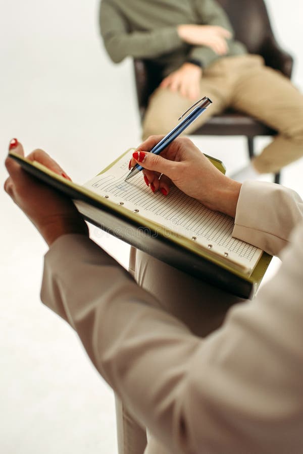 Close-up of a Notebook with a Pen in the Hands of a Psychologist Taking ...