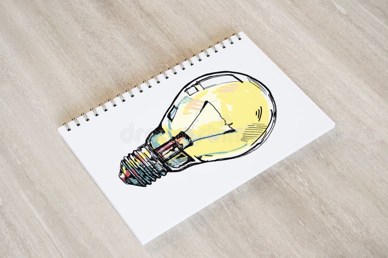 Close Up of Notepad with Creative Light Bulb Sketch on Wooden Desk ...