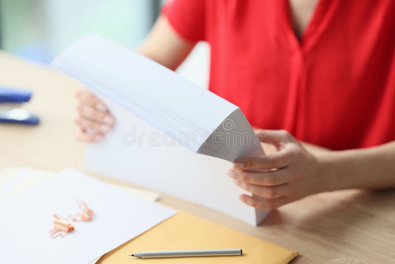Close-up of Office Manager Holding Stack of Blank Paper while Sitting ...
