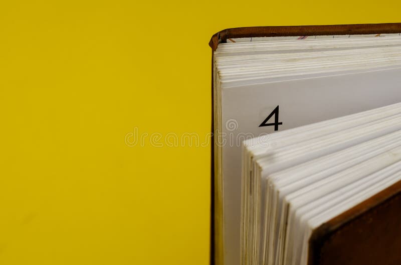 Close-up of an Old Diary Standing on the Endpaper Against a Yellow ...
