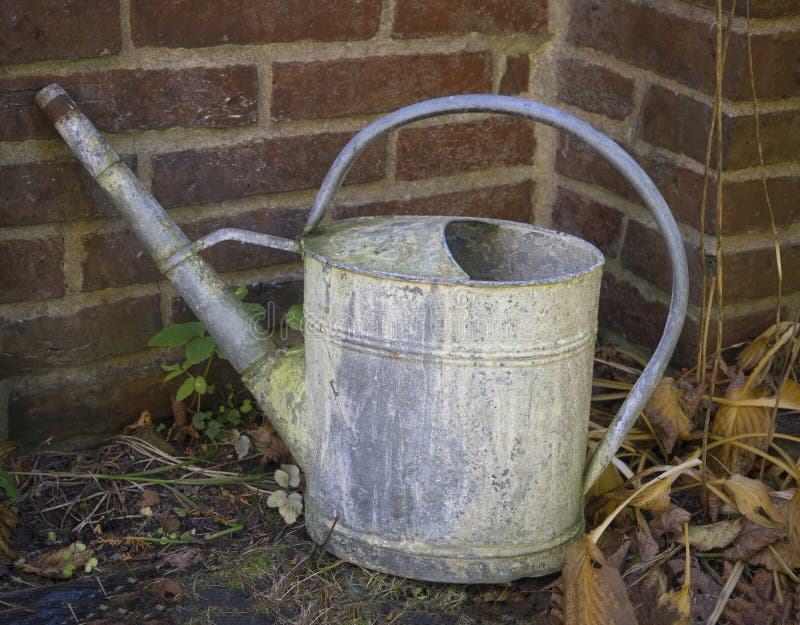 Close Up Old Rusty Tin Watering Can in Cemetery Wall Stock Image ...