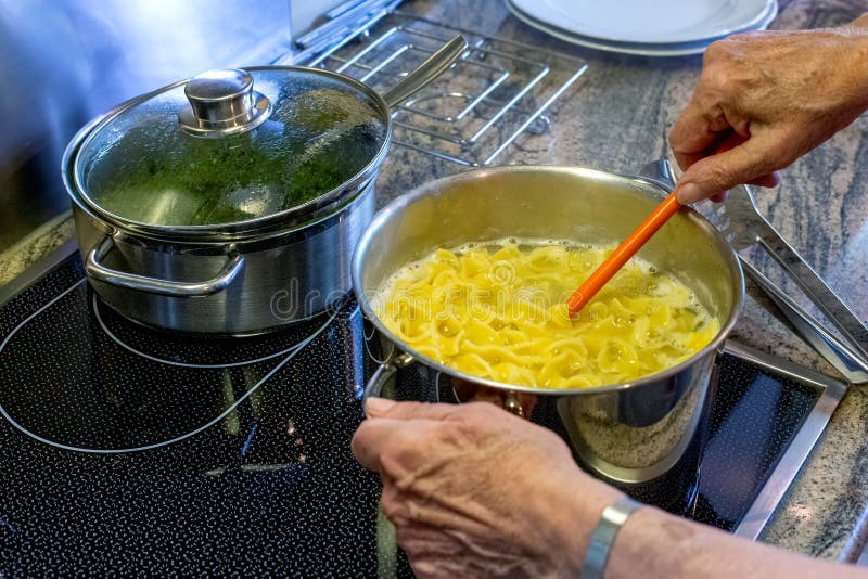 Close-up of Old Womans Hands and Stove with Pot and Pasta Stock Photo ...