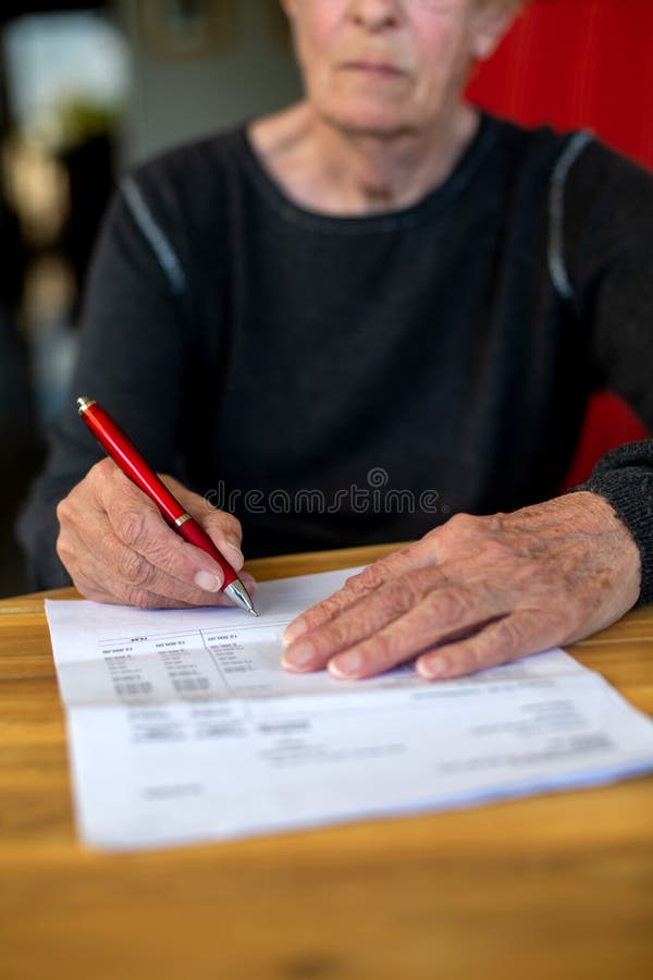 Close-up of Older Womans Hand Signing a Paper Stock Photo - Image of ...