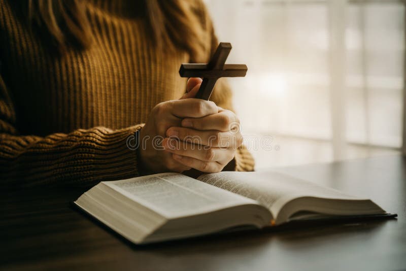 Close Up of an Open Bible with a Cross for Morning Devotion on a Wooden ...