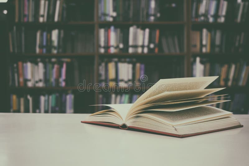 Close Up of Open Book on Desk with Vintage Filter Blur Background Stock ...