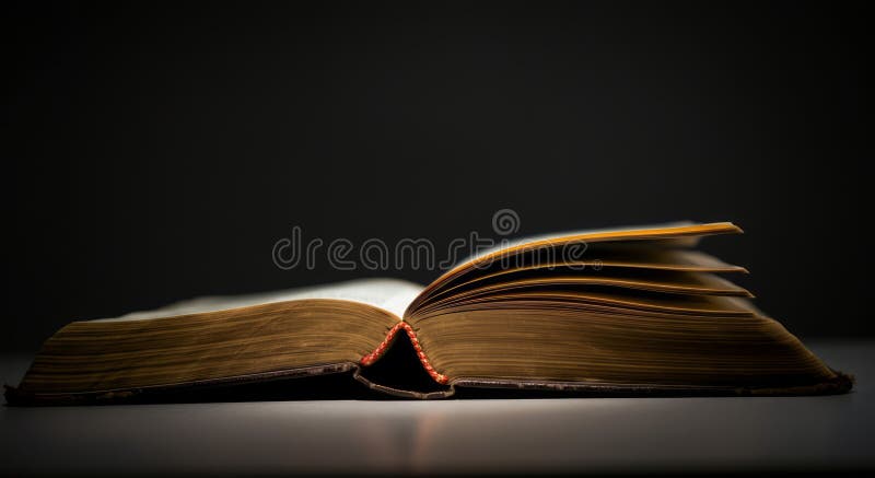 Close-up of an Open Old Book with Curled Pages in Low Light Stock Photo ...