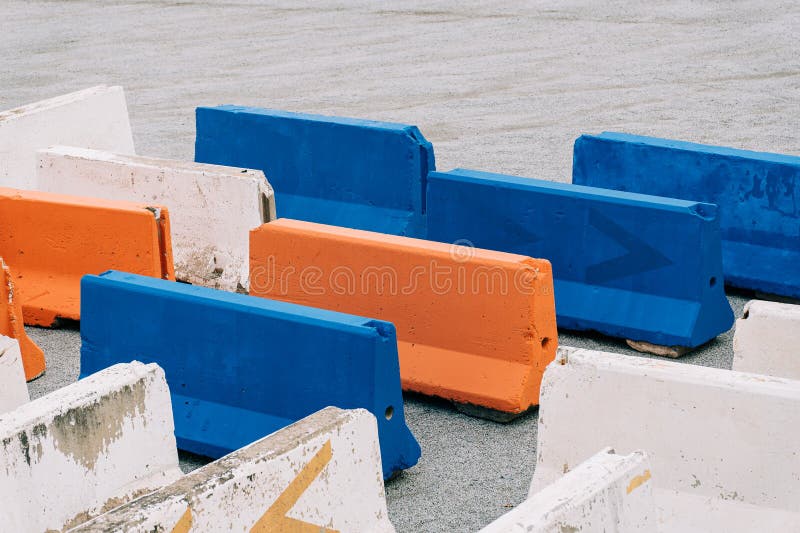 Close-up of Orange, Blue, and White Concrete Barriers Arranged on a ...