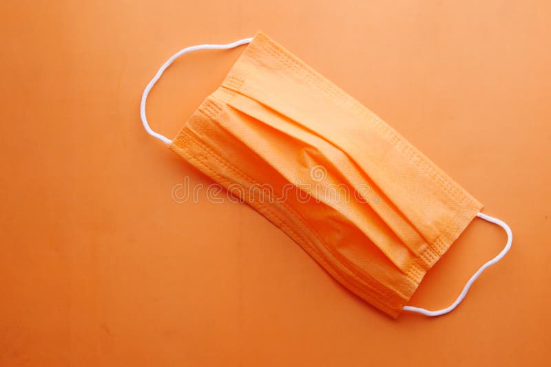 Close Up of Orange Color Surgical Masks on Color Background Stock Photo ...