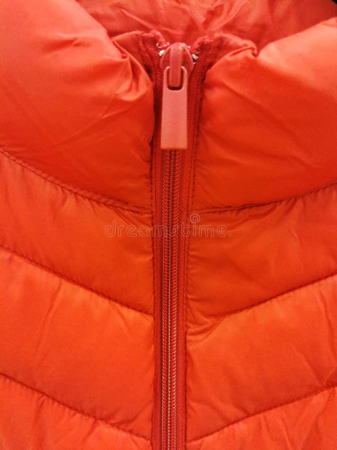 Close-up on Orange Puffer Jacket Texture with a Zipper and a Runner ...