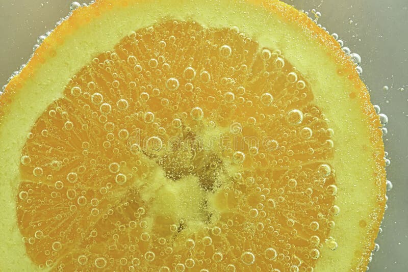 Close-up of an Orange Slice in Liquid with Bubbles. Slice of Ripe ... Close-up of an Orange Slice in Liquid with Bubbles. Slice of Ripe ...