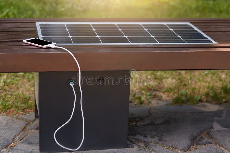 Close Up Outdoor Image of Smartphone Charging Via USB in Park with Help ...