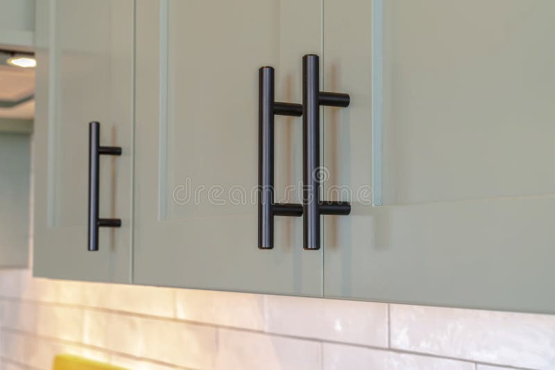 Close Up of Overhead Kitchen Cupboards and Handles Stock Image - Image ...