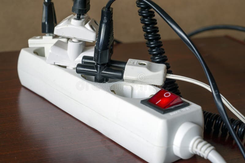 Multiple Plugs Inserted in an Electrical Power Strip with Cables Stock ...