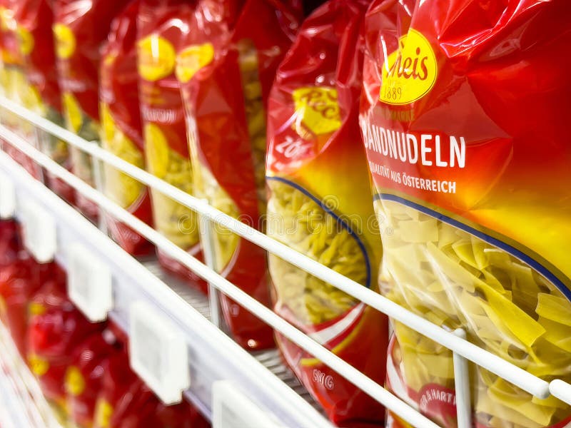 Close-up of Packaged Pasta on Grocery Store Shelf Display with Red and ...
