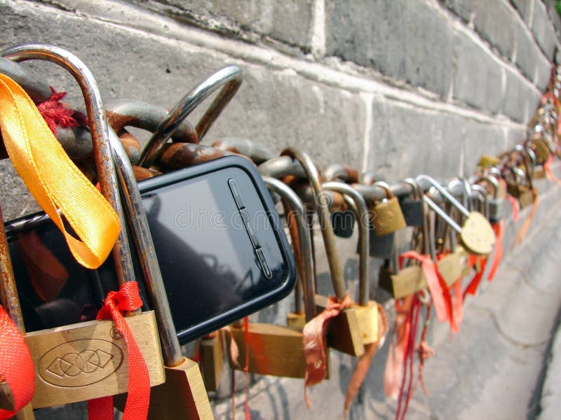 Close Up of Padlocks and Mobile Phone on a Chain. the Great Wall of ...