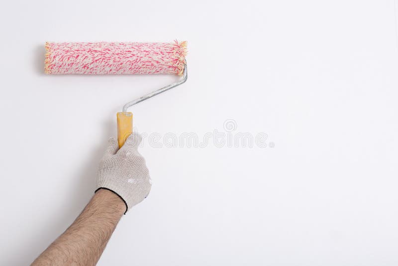 Close Up of Painter Arm Painting a Wall with Red Paint Roller Stock ...