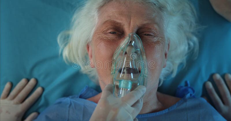 Paramedics Putting On Oxygen Inhalation Mask On Girl Face While Trying