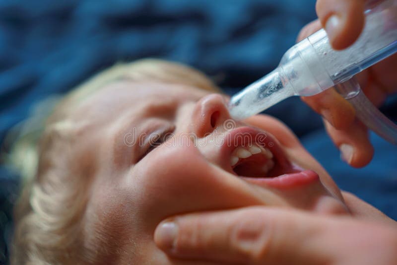 Close-up of Parent Holding His Son and Using Snot Extractor. Stock ...