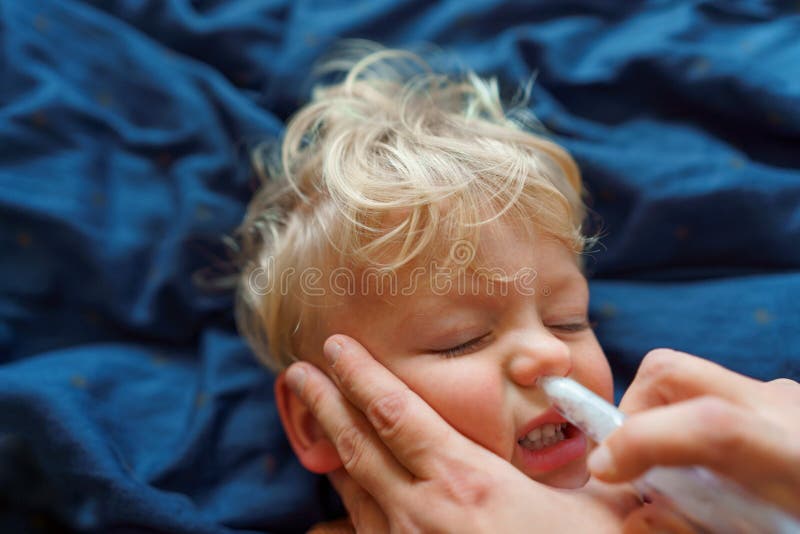 Close-up of Parent Holding His Son and Using Snot Extractor. Stock ...