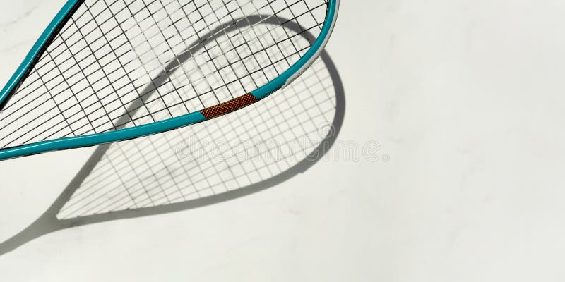 Close-up of Part of a Racket Brightly Lit by the Sun, Casting a Hard ...