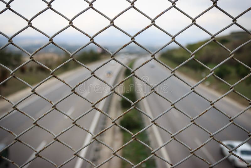 Pattern of Wire Mesh Fence. Highway at Background Stock Image - Image ...