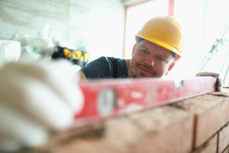Pedantic Man Using Level Tool To Measure Height of Brick Wall Stock ...