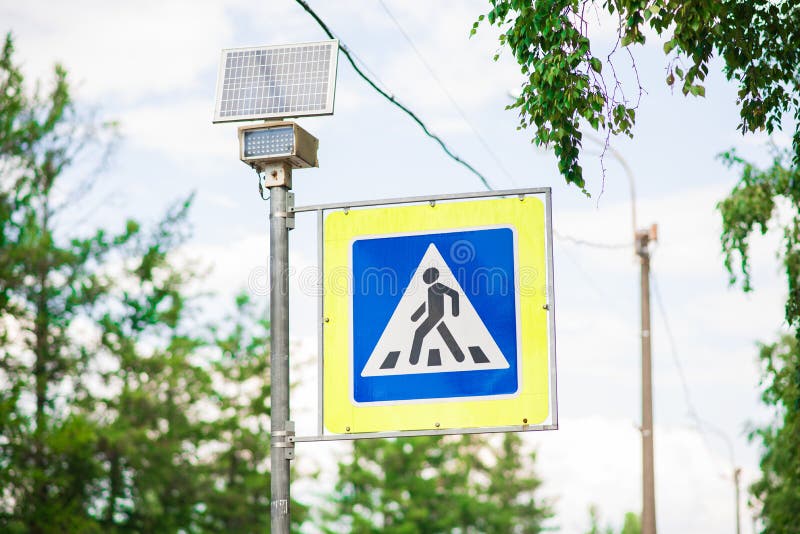 A Close-up of a Pedestrian Crossing Sign with a Solar Panel Outside ...