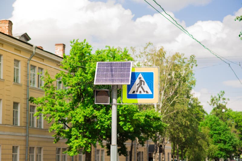 A Close-up of a Pedestrian Crossing Sign with a Solar Panel Outside ...
