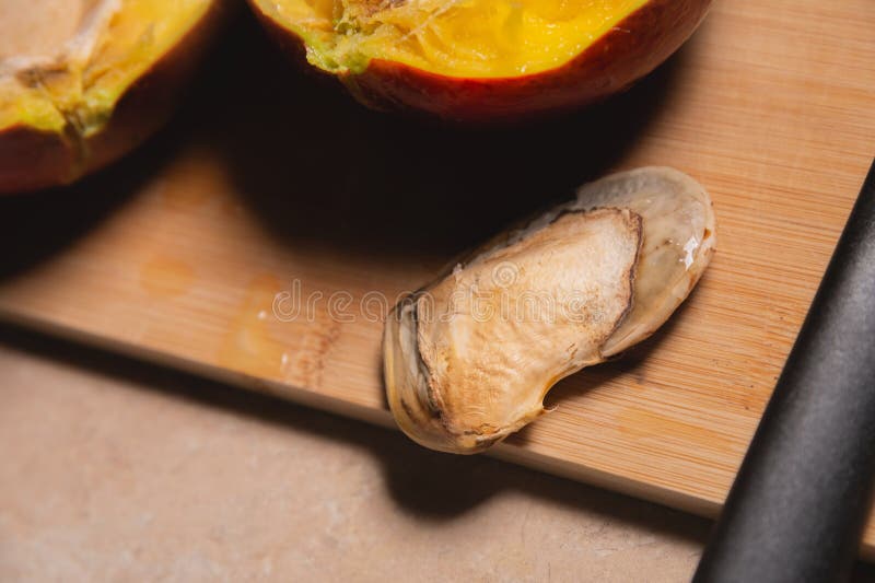Close-up of a Peeled Mango Pit, Cut Mango on a Bamboo Board Stock Image ...