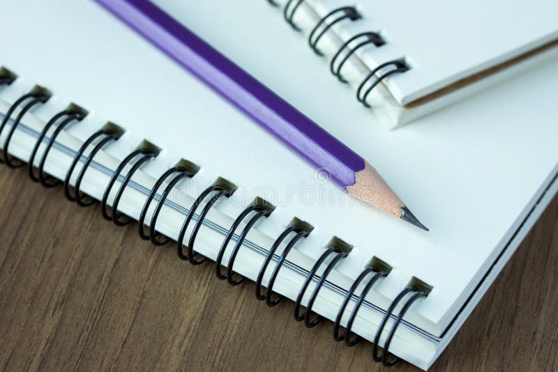 Close Up Pencil and Spiral Notebook on Wood Table Stock Image - Image ...