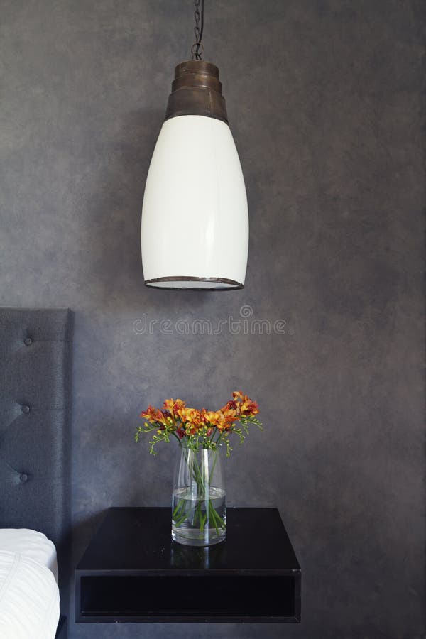 Close Up of Pendant Light and Flowers on Bed Side Table Stock Image ...