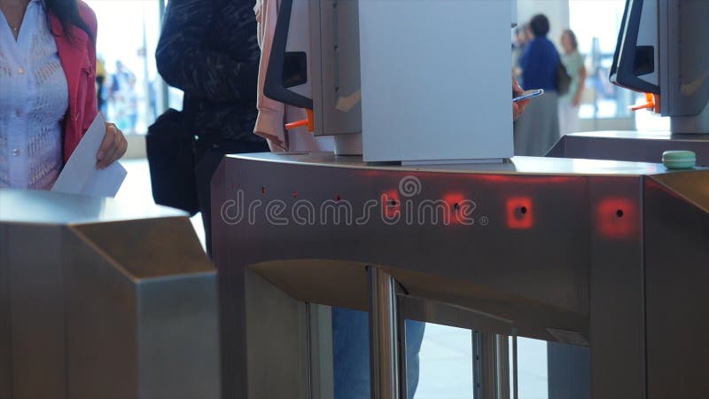 Close-up of People Passing Electronic Turnstile with Barcode Scanner ...