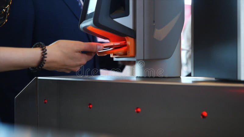 Close-up of People Passing Electronic Turnstile with Barcode Scanner ...