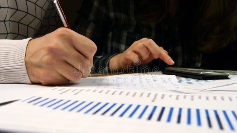 Close-up of People Using Graphs To Work on a Desk Stock Photo - Image ...