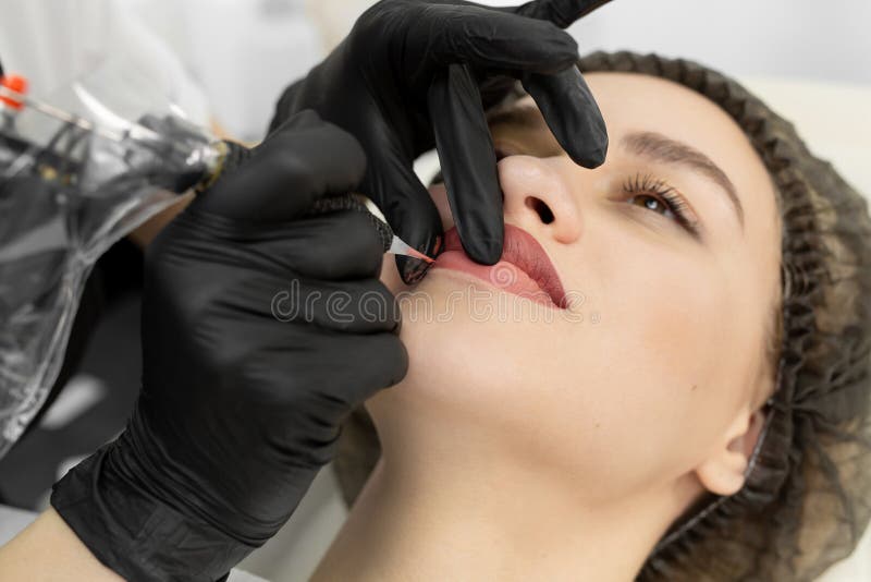 Close-up of the Permanent Makeup Procedure. Lip Makeup in the ...