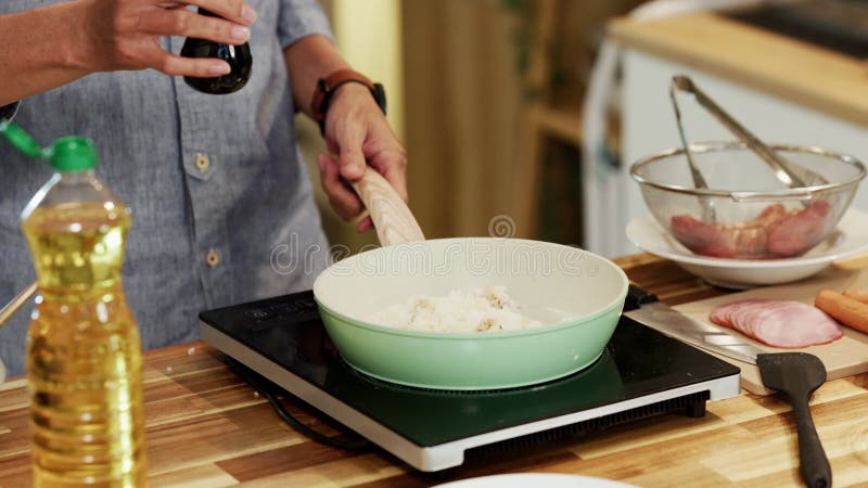 Close Up of a Person Adding Soy Sauce To a Pan of Rice, Process of ...