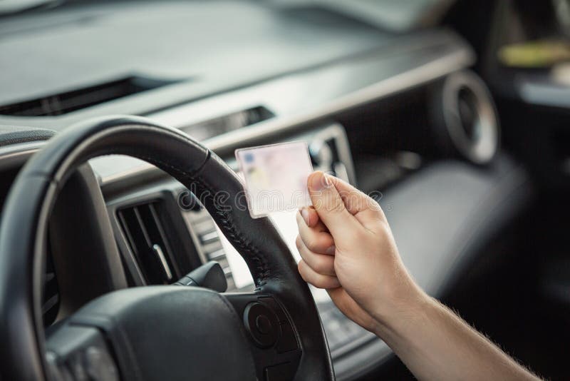 Close Up Person Hand Holding the Driver License in Front of the ...