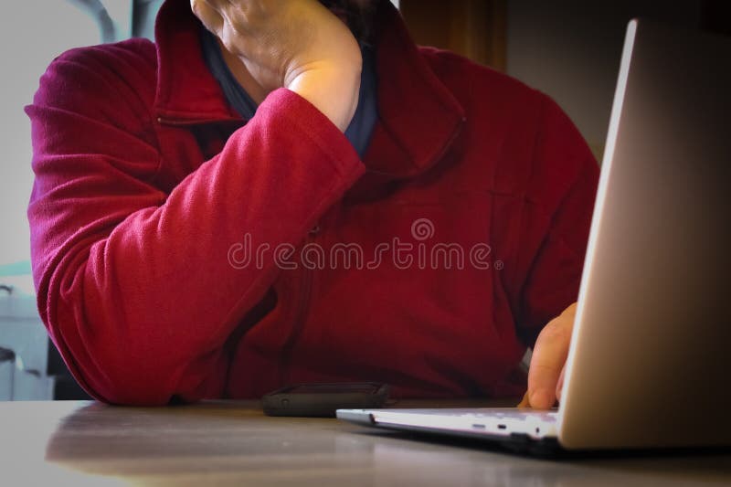 Close-up of Person Looking at Computer Screen with Smartphone on Table ...