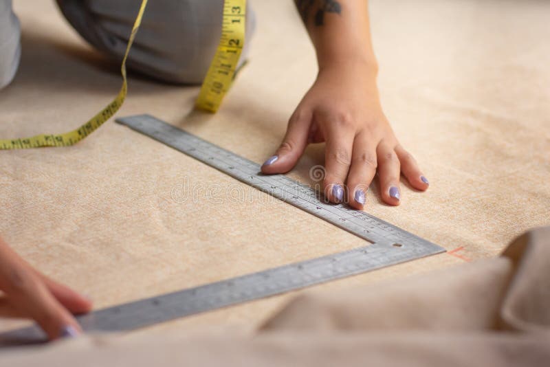 Close Up of a Seamstress Woman Who is Measuring Fabric Using Rules ...