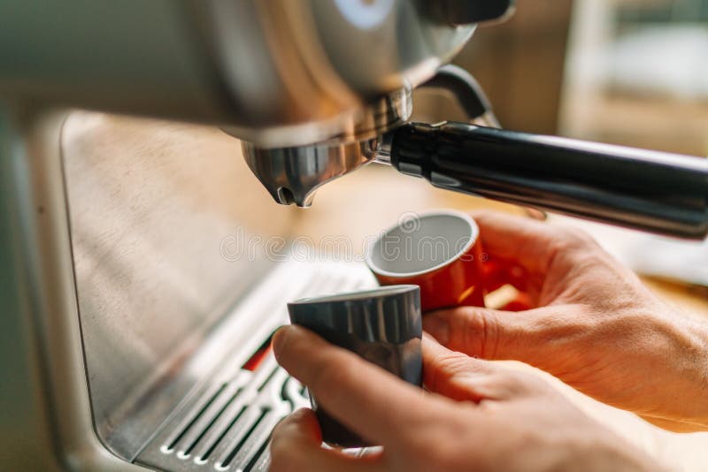 Close-up of a Person Preparing Espresso with a Coffee Machine in a Cozy ...
