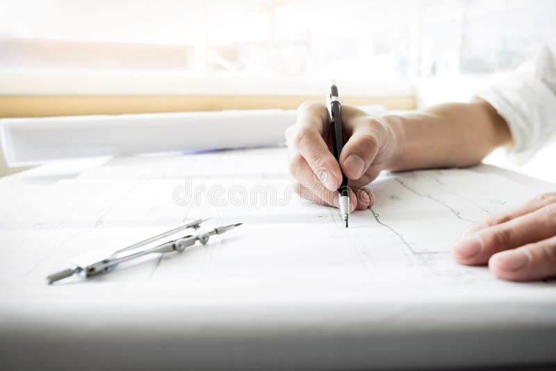 Close-up of Person& X27;s Engineer Hand Drawing Plan on Blue Print Wi ...