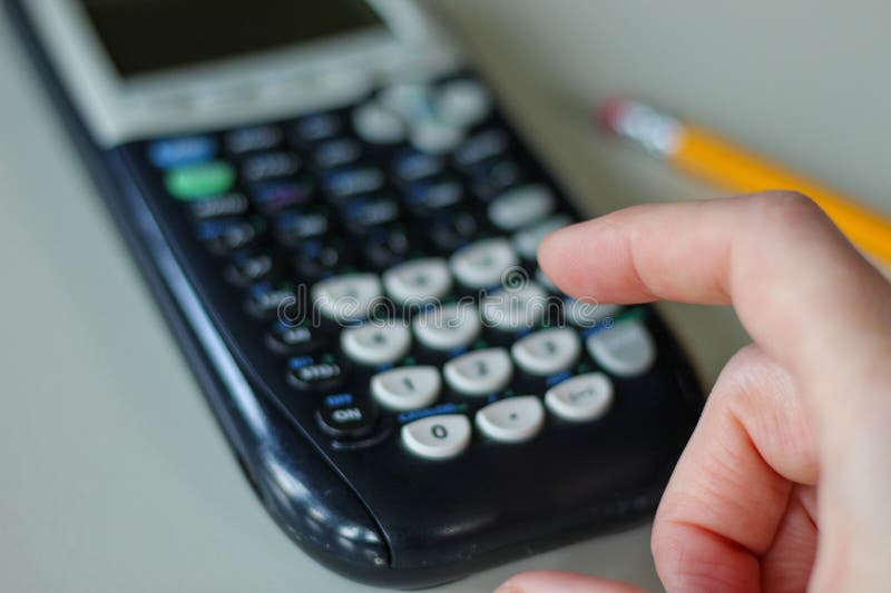 Close-up of Person Using Calculator with Pencil on Table on White ...