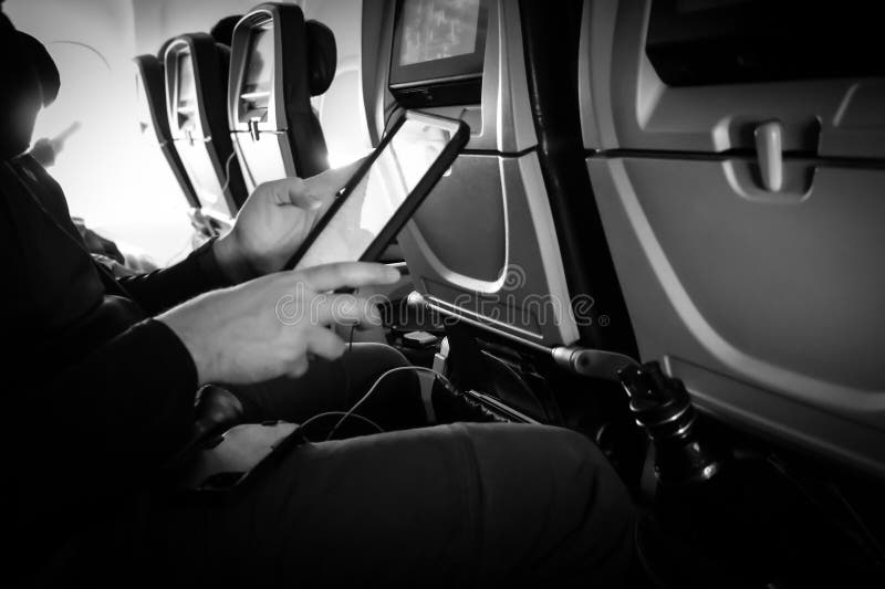 Close-up of Person Using an Electronic Device during a Flight. Air ...