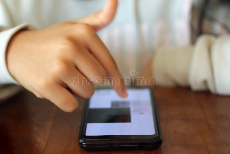 Close Up of a Person Using a Smartphone Computer with a Finger Pointing ...