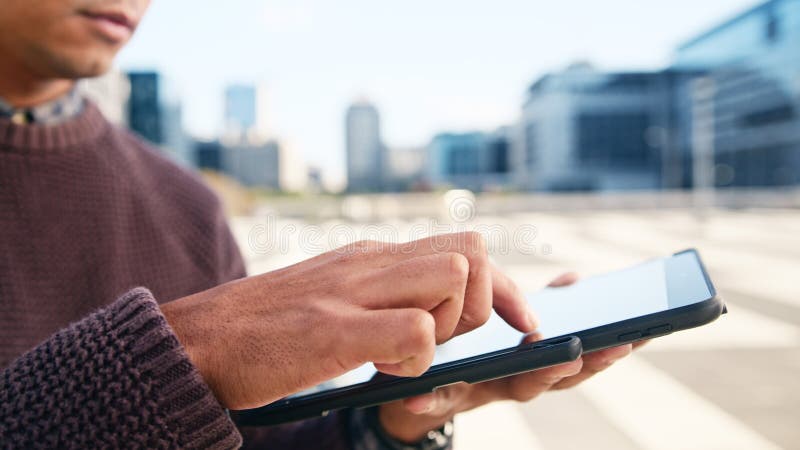 Close-Up of Person Using Tablet Outdoors in Urban Environment Stock ...