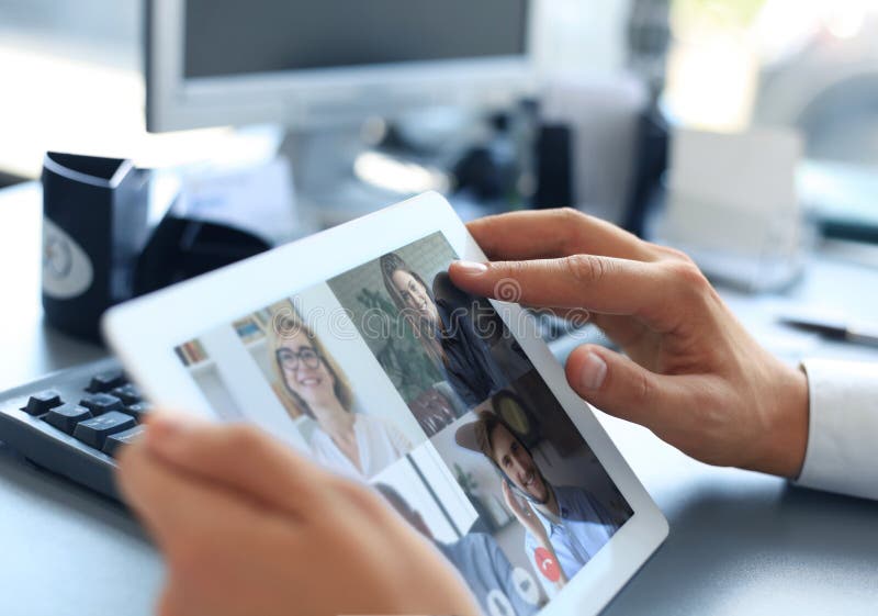 Close Up of Person Video Conferencing with Colleagues on Digital Tablet ...