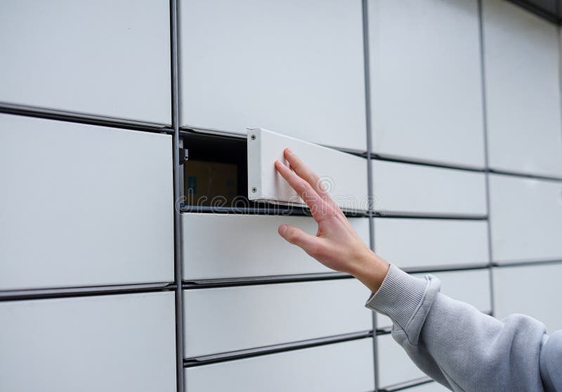 Hand Closing a Parcel Locker Door after Picking Up a Package. Modern ...