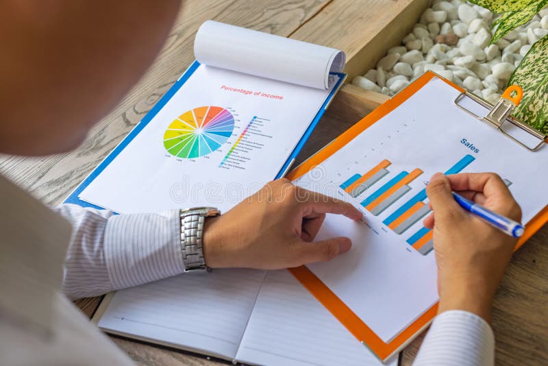 Close Up Photo of Businessman Working on Sales Chart Document Stock ...