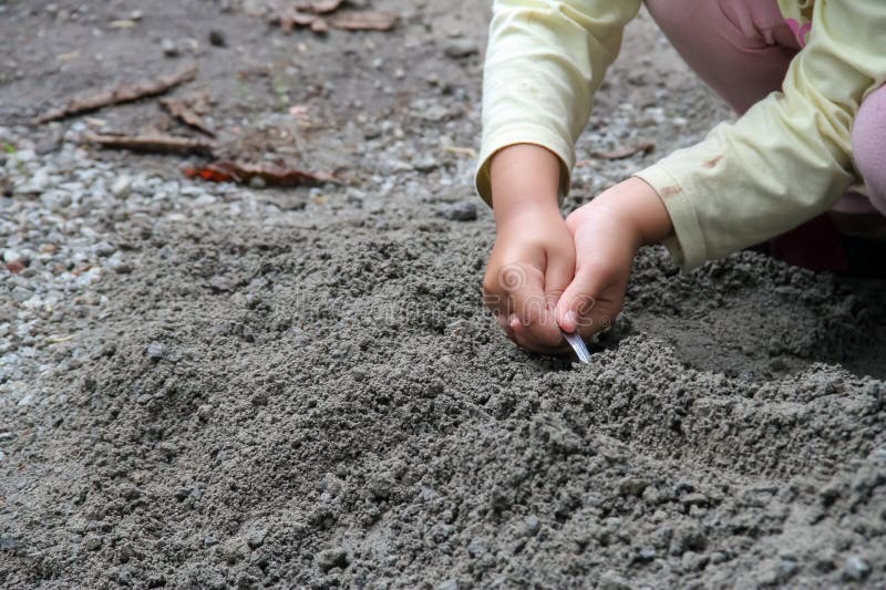 Close Up Photo of a Child& X27;s Hand Using a Spoon To Play with Sand ...