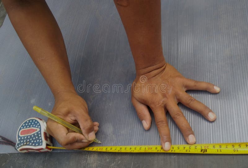 Close Up Photo of a Craftsman& X27;s Hand Making Measurements with a ...